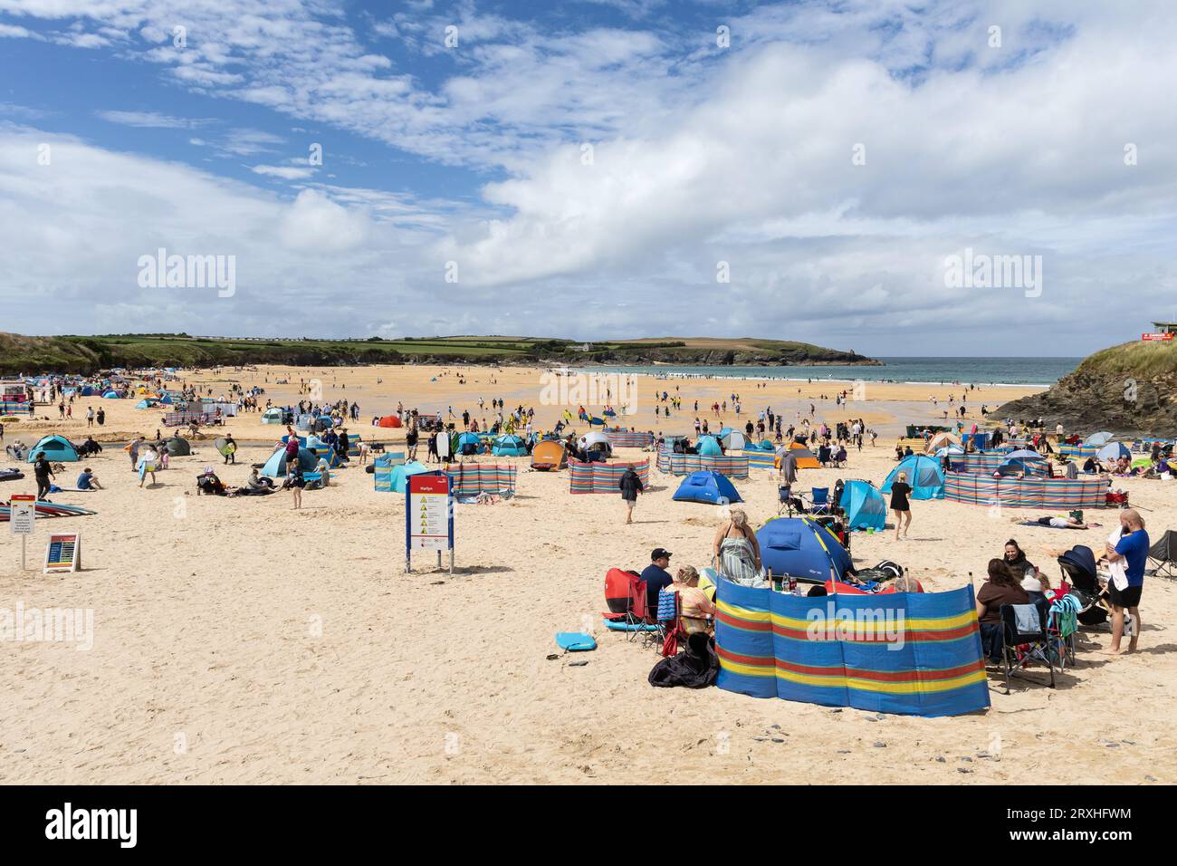 Holidaymakers enjoying a bright summer's day on the wide sandy beach at ...