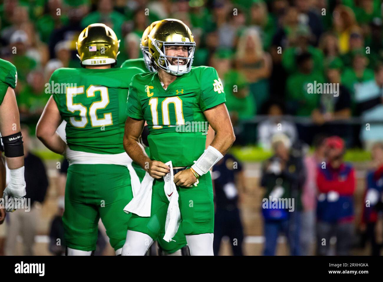 Notre Dame's Sam Hartman (10) smiles as he walks back to the huddle ...