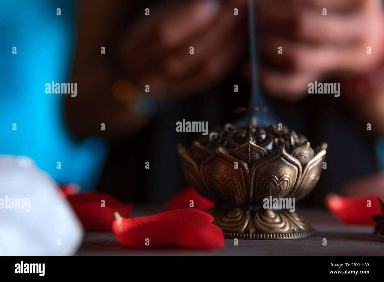 Close-up of hands lighting an incense, witch on the day of the dead ...