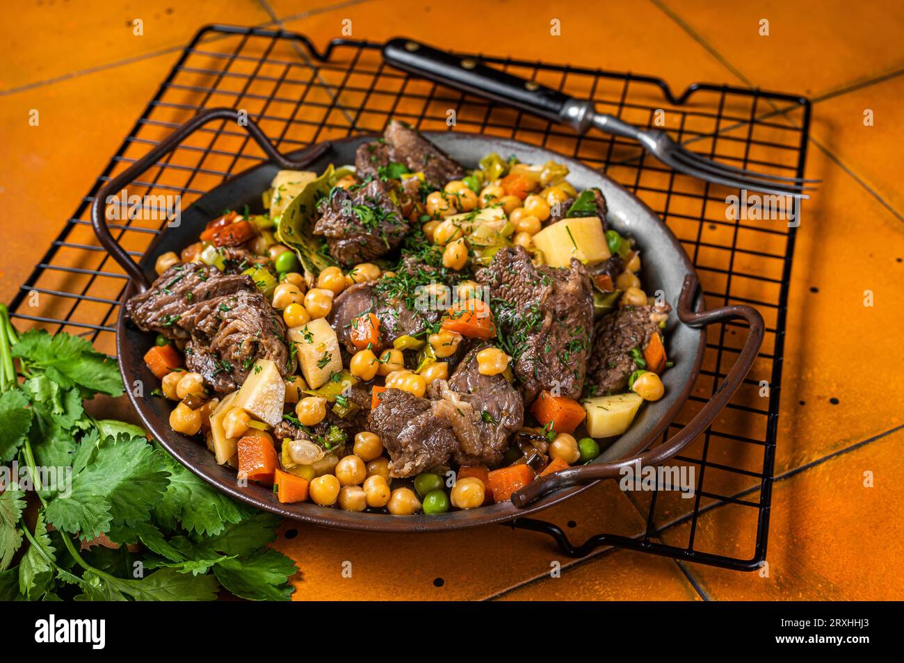 Spanish cocido Madrid stew with chickpeas, meat, carrots and potatoes ...