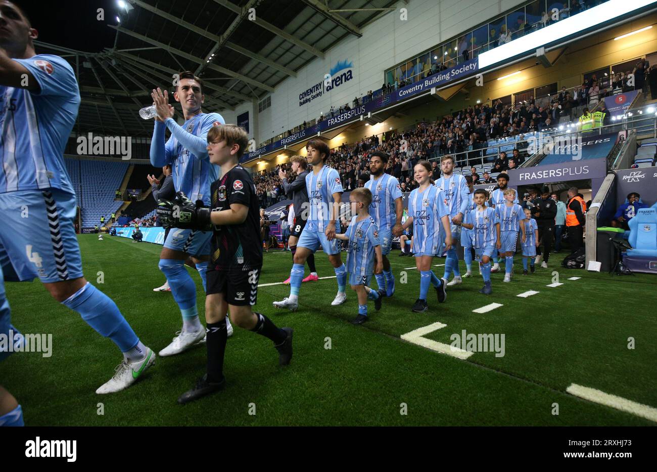 Coventry City matchday mascots walk out with the players before the Sky ...