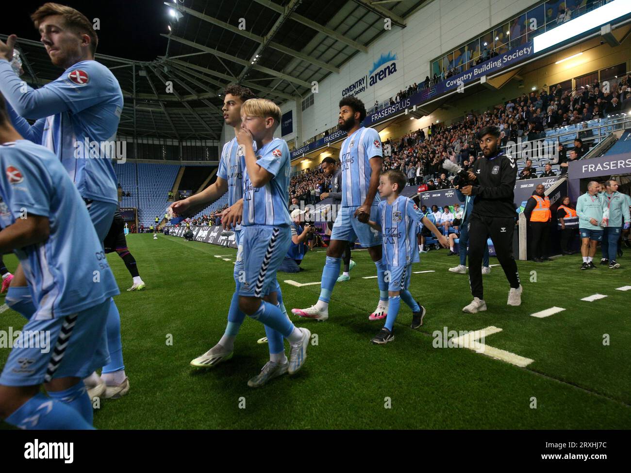 Coventry City matchday mascots walk out with the players before the Sky ...