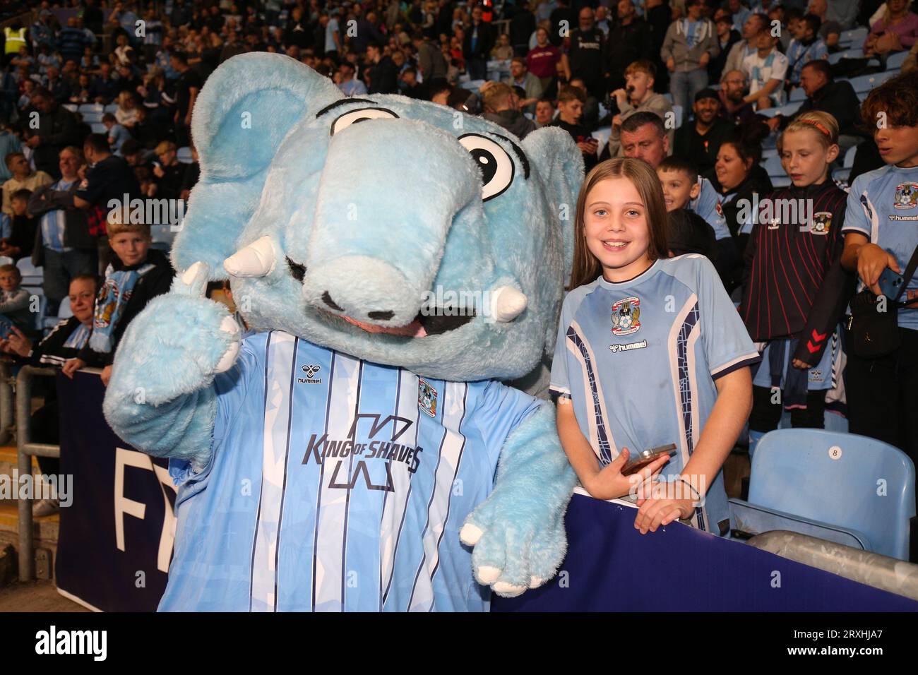 Coventry City mascot Sky Blue Sam poses for a photo with fans at half ...