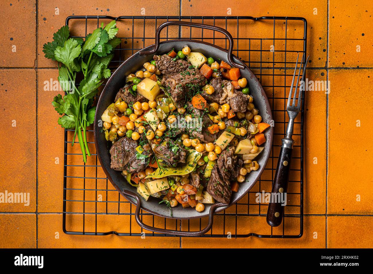 Spanish cocido Madrid stew with chickpeas, meat, carrots and potatoes ...