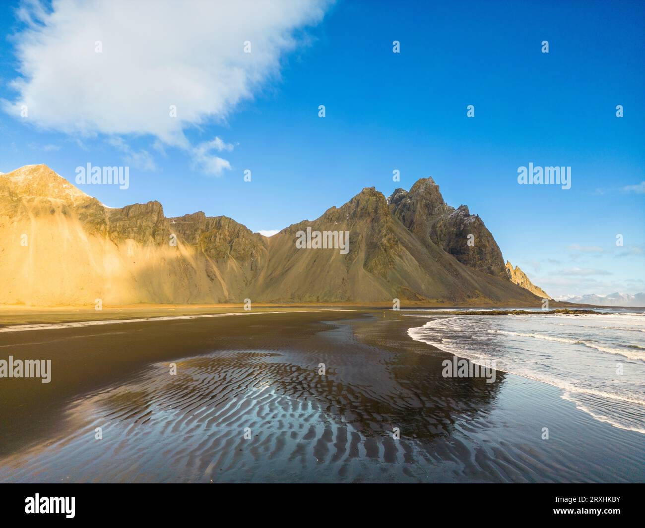 Aerial view of stokksnes black sand beach with massive rocky mountain ...