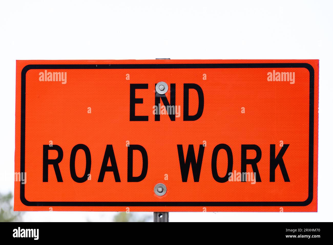 Orange sign indicating the end of road work area Stock Photo - Alamy