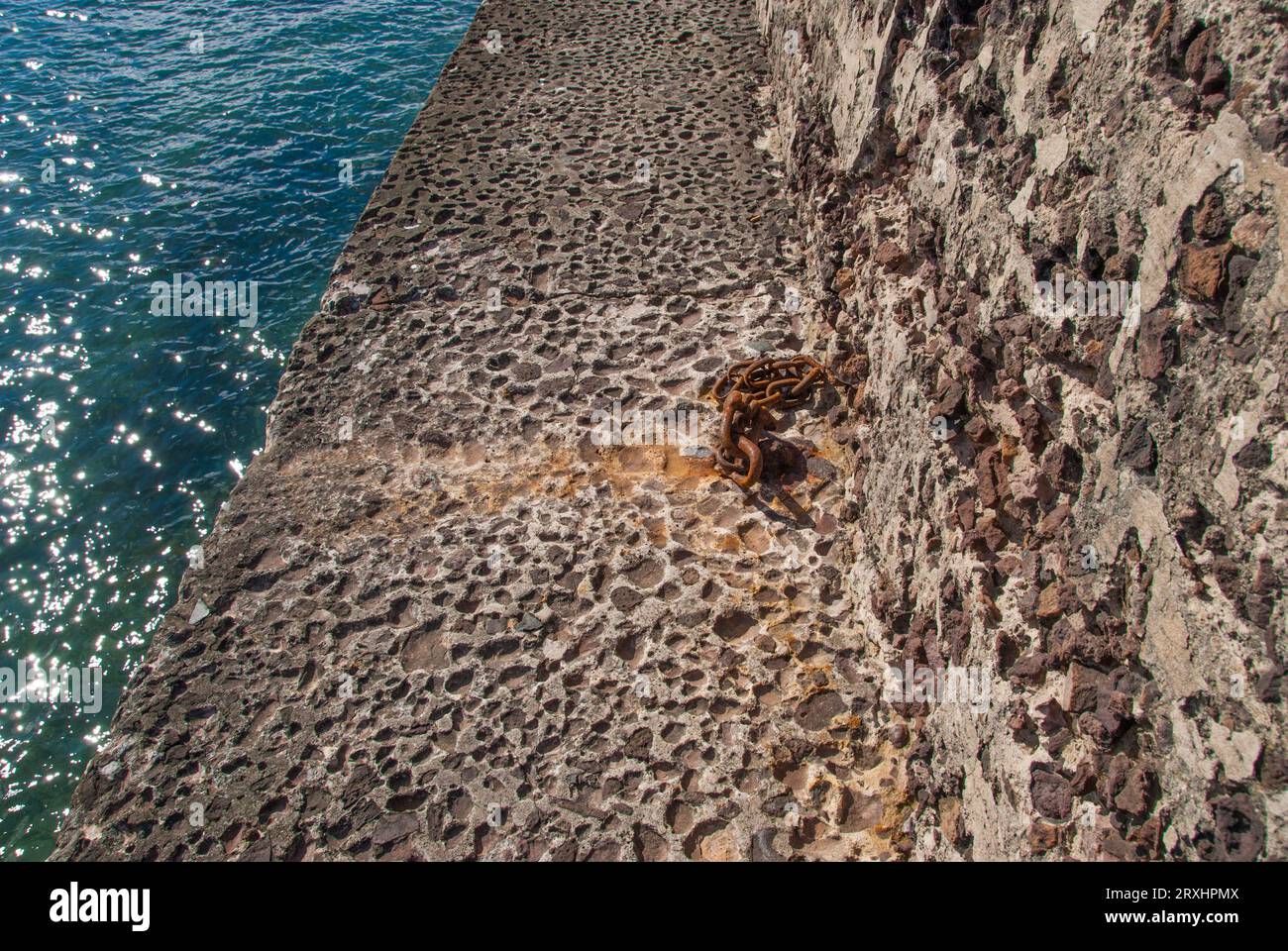 Rusty mooring shackle and chain on sea wall, Shell Harbour, New South ...
