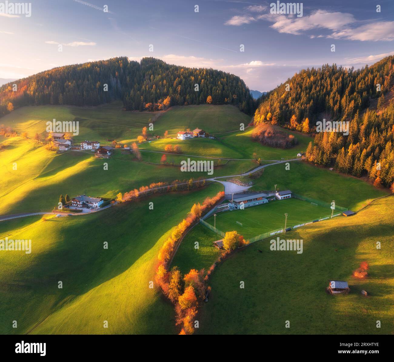 Aerial view of amazing green alpine meadows, orange trees, hills Stock ...