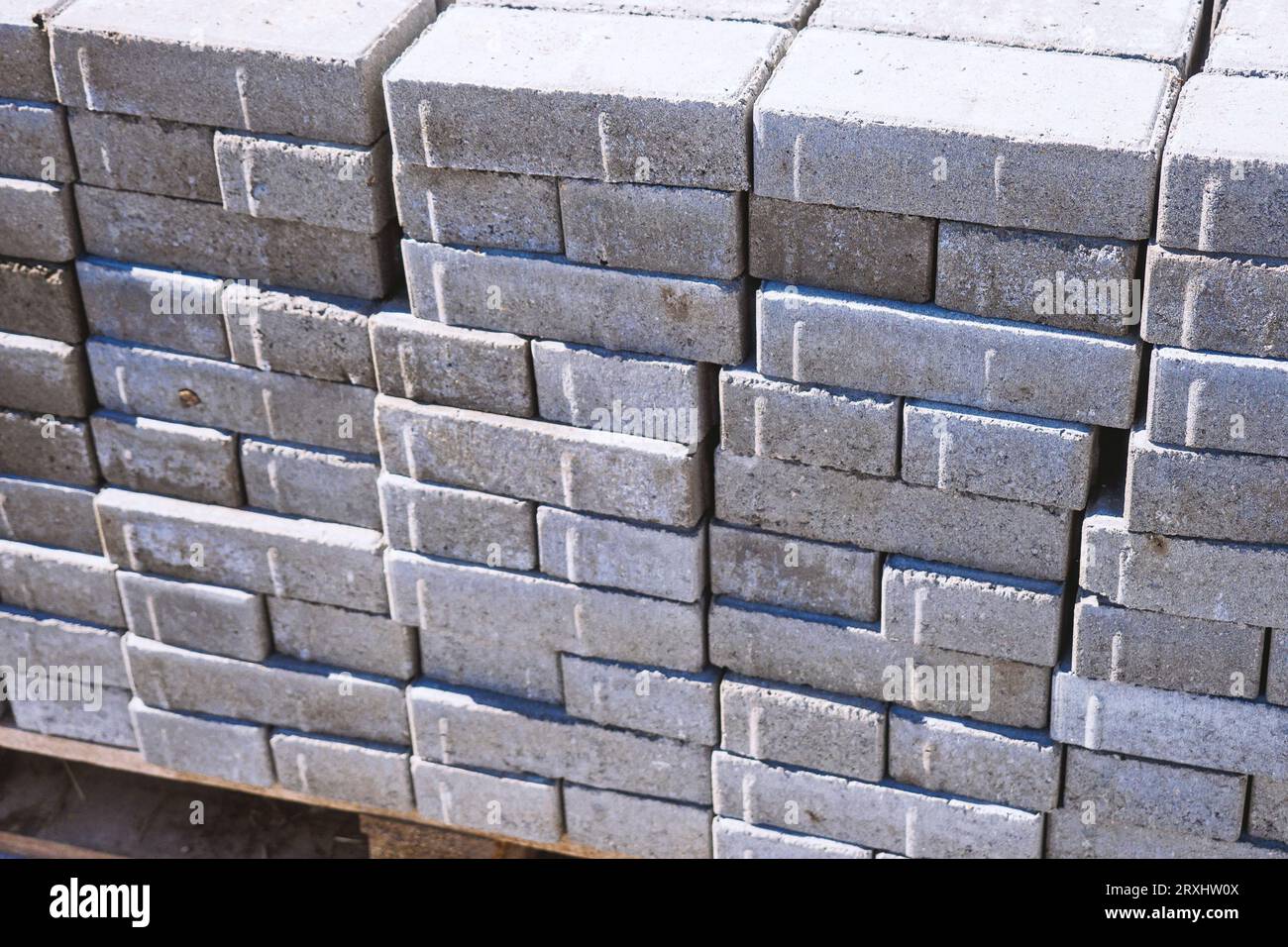 Gray sand-lime brick. New bricks for laying sidewalk lie in stacks on ...