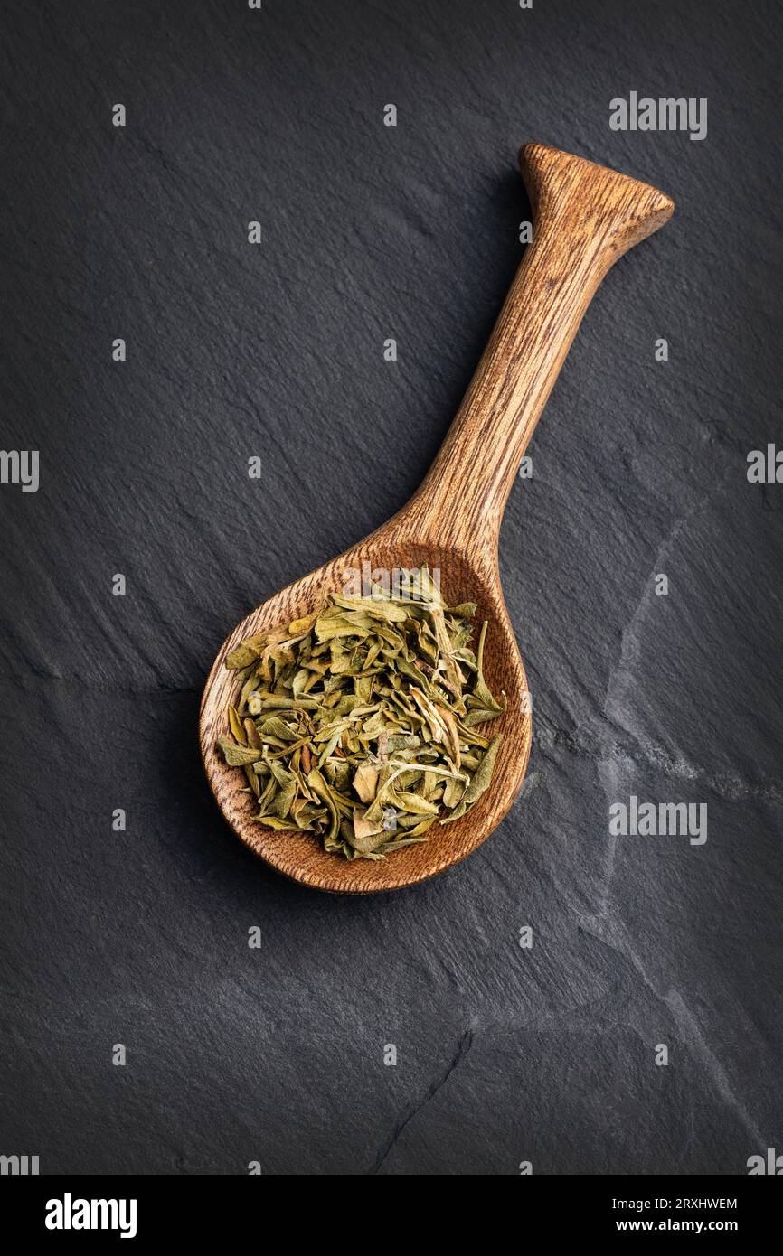 Dried rue leaves in the spoon - Ruta graveolens Stock Photo - Alamy