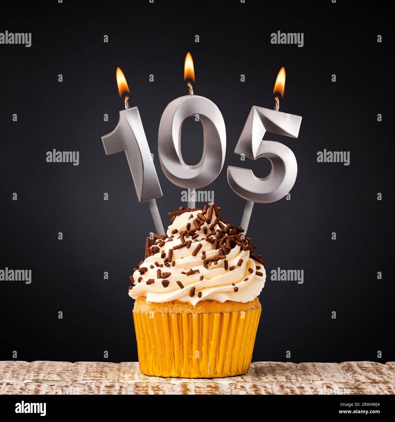 Birthday candle number 105 - Anniversary cupcake on black background ...
