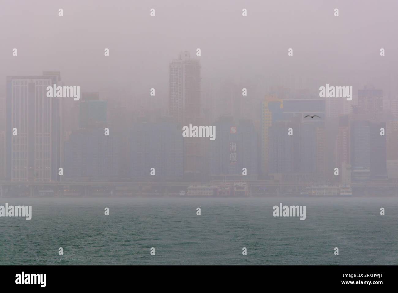 Fog and rain over modern high rise buildings in Hong Kong's Victoria ...