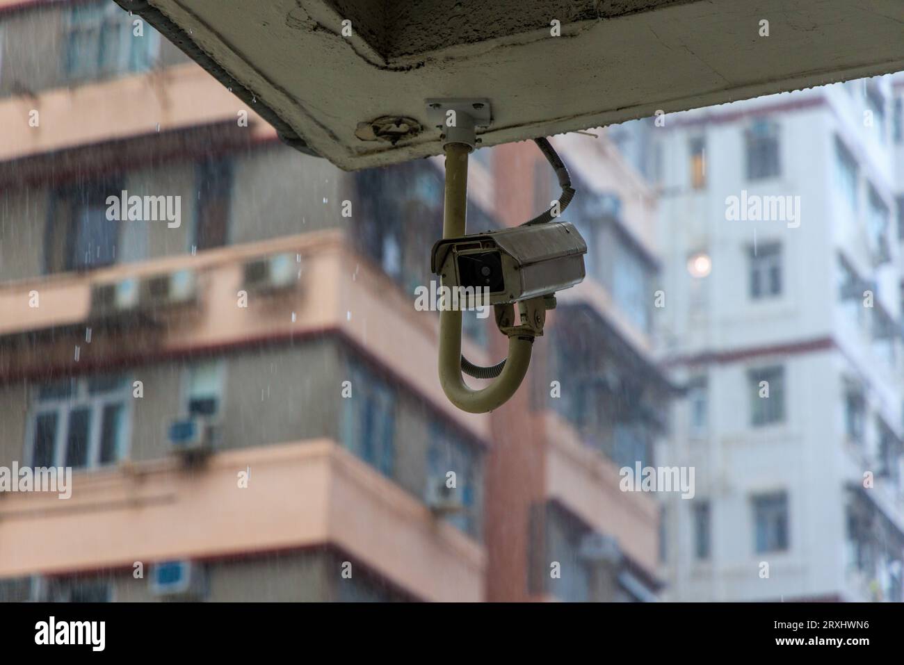 Security surveillance camera on high-rise apartment building in rain ...