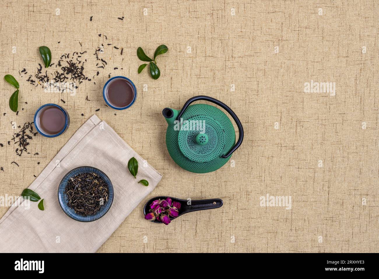 An Asian style tea service with cast iron teapot, tea leaves, dried ...