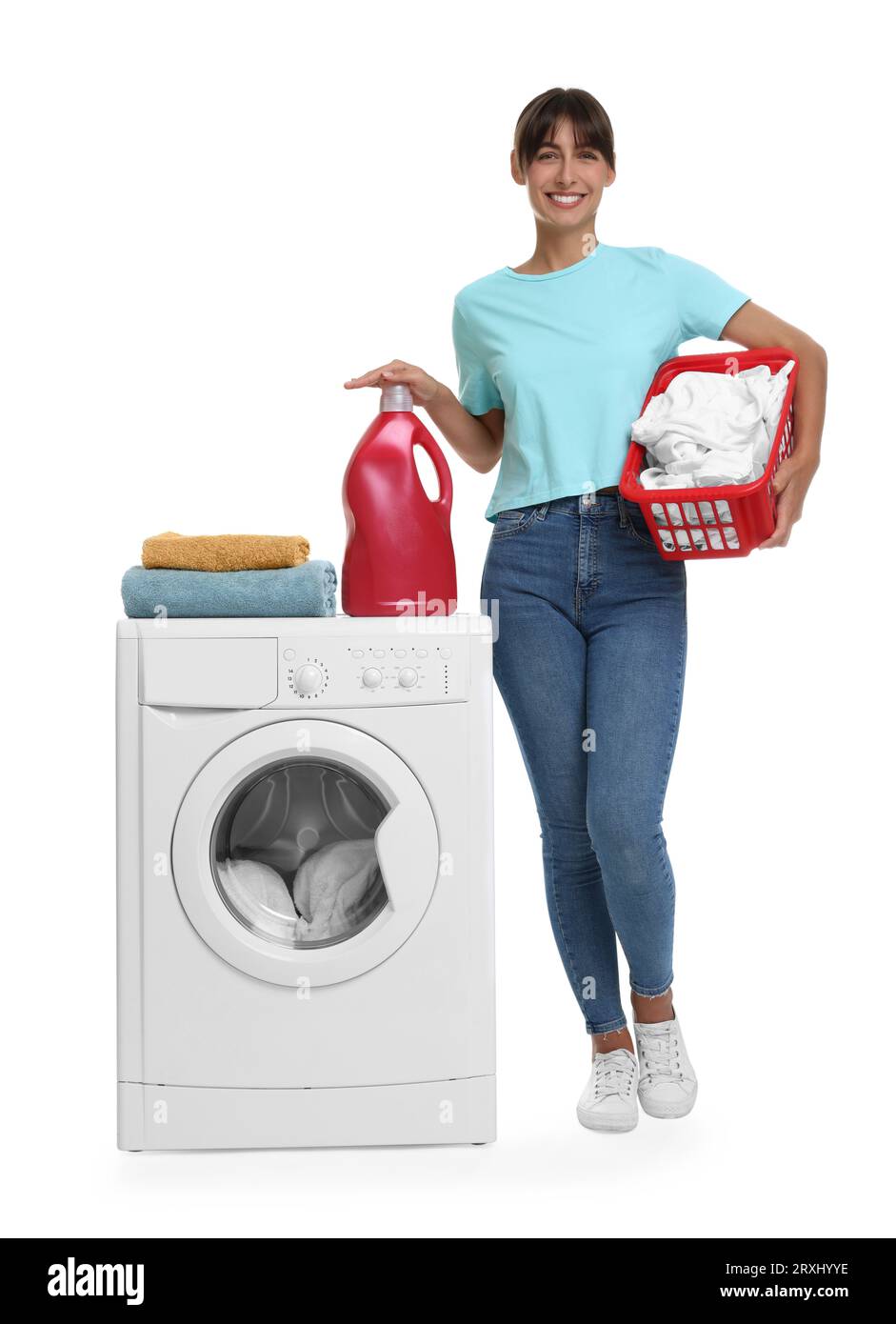 Beautiful woman with laundry basket and detergent near washing machine against white background ...