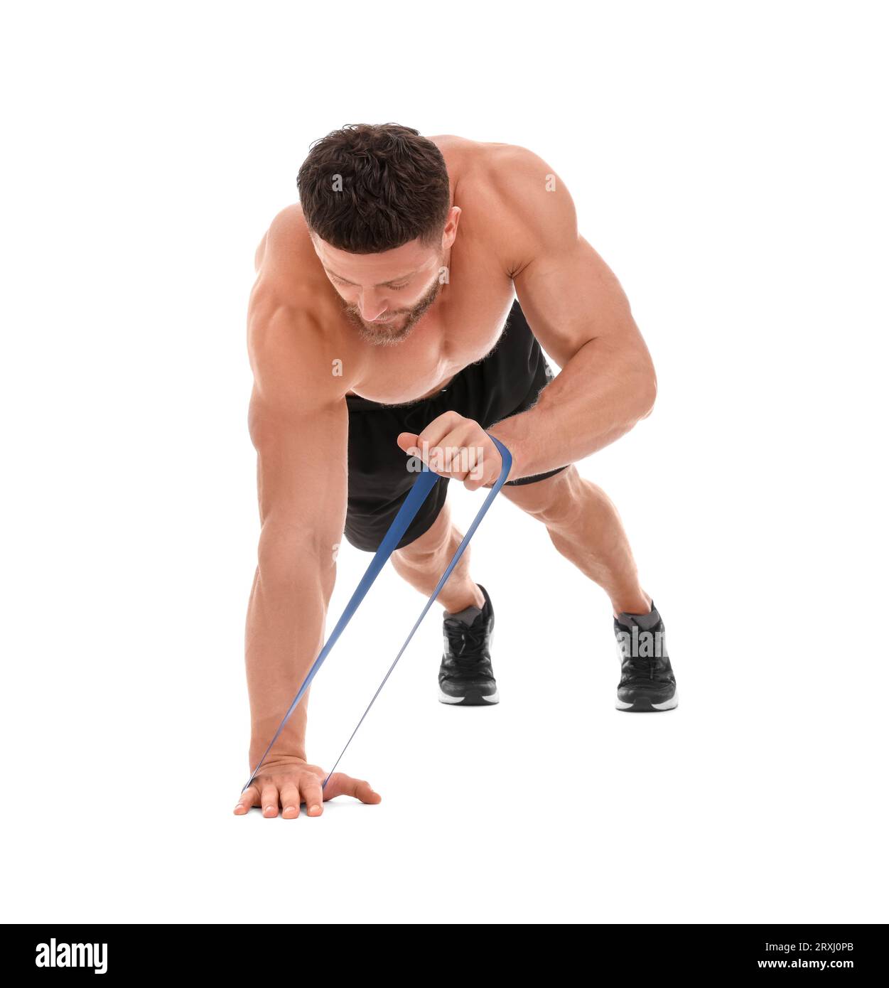 Young man exercising with elastic resistance band on white background ...