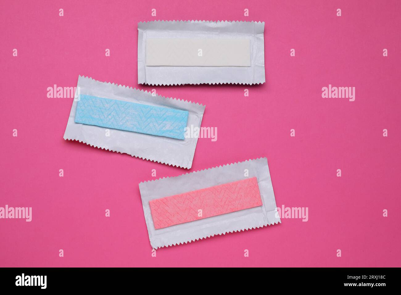 Unwrapped sticks of tasty chewing gum on bright pink background, flat ...