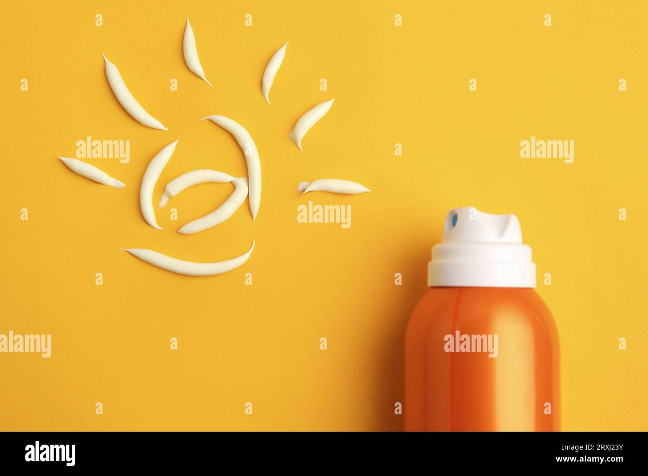 Drawing of sun and bottle with sunscreen on orange background, top view ...