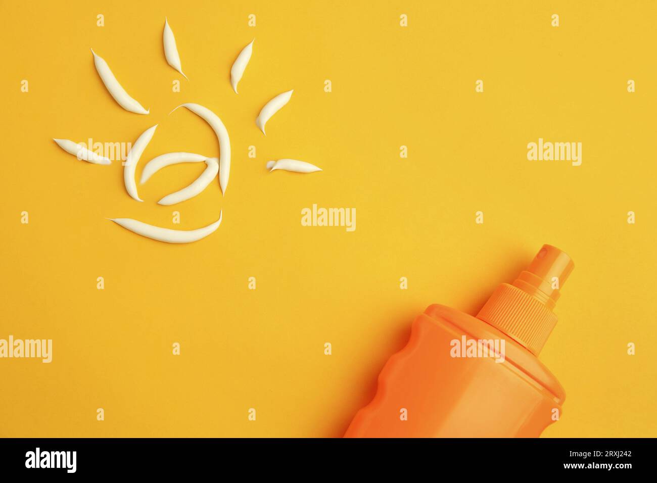 Drawing of sun and bottle with sunscreen on orange background, top view ...