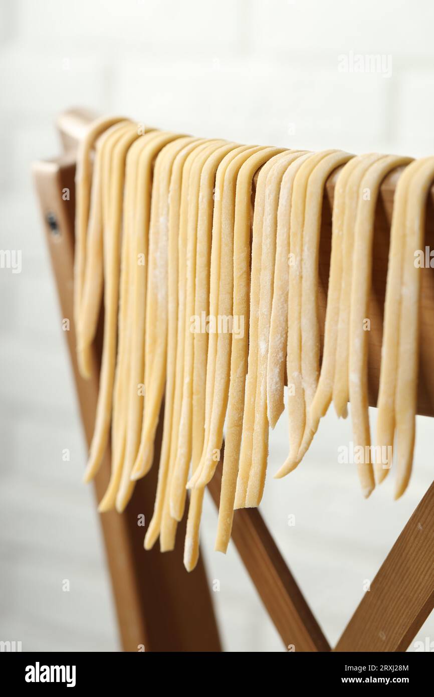 Homemade pasta drying on chair against white background, closeup Stock ...