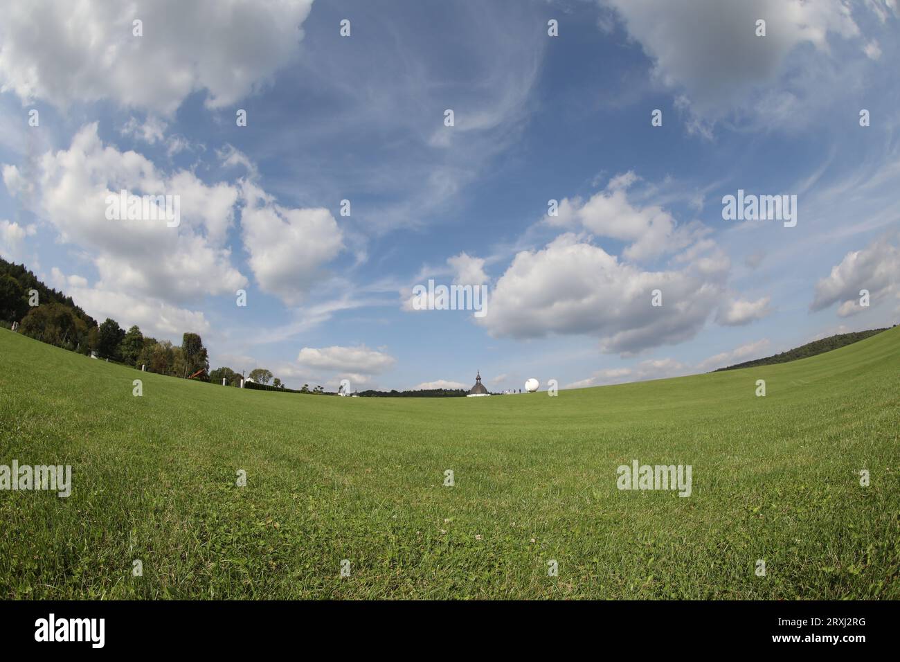 Beautiful lawn with green grass growing under blue sky. Fisheye lens ...