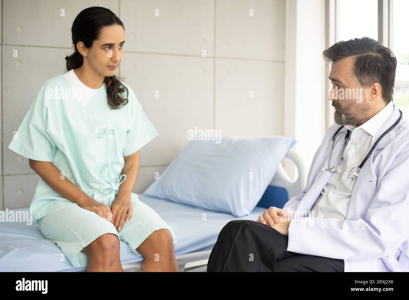 Caucasian male physician diagnosis for root cause finding with Hispanic ...