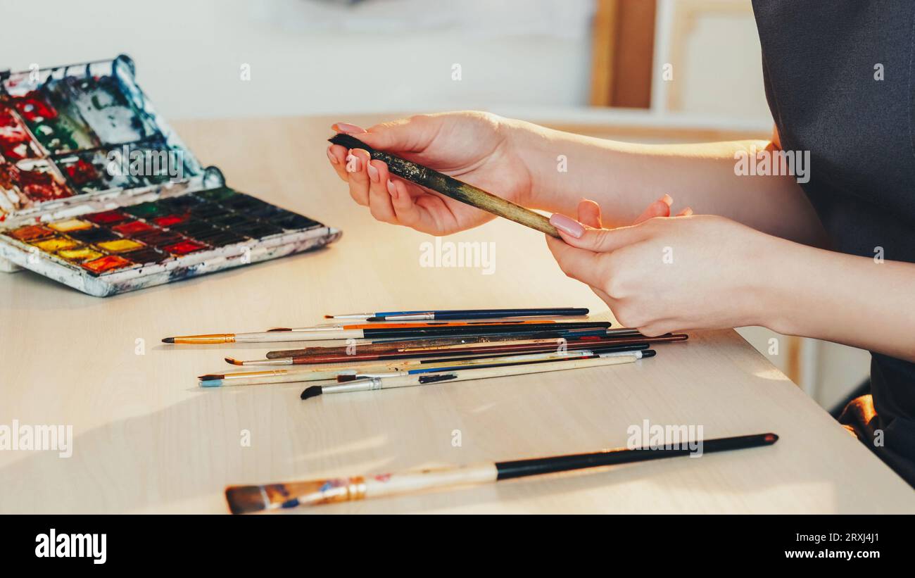 Art tools painting accessories woman artist hands Stock Photo - Alamy