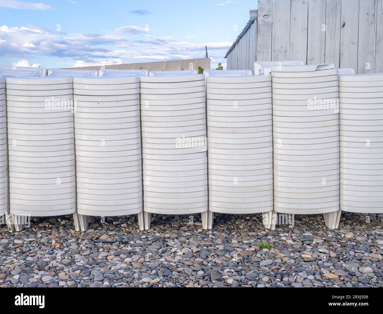 Folded sunbeds on the beach. End of season concept at the resort ...