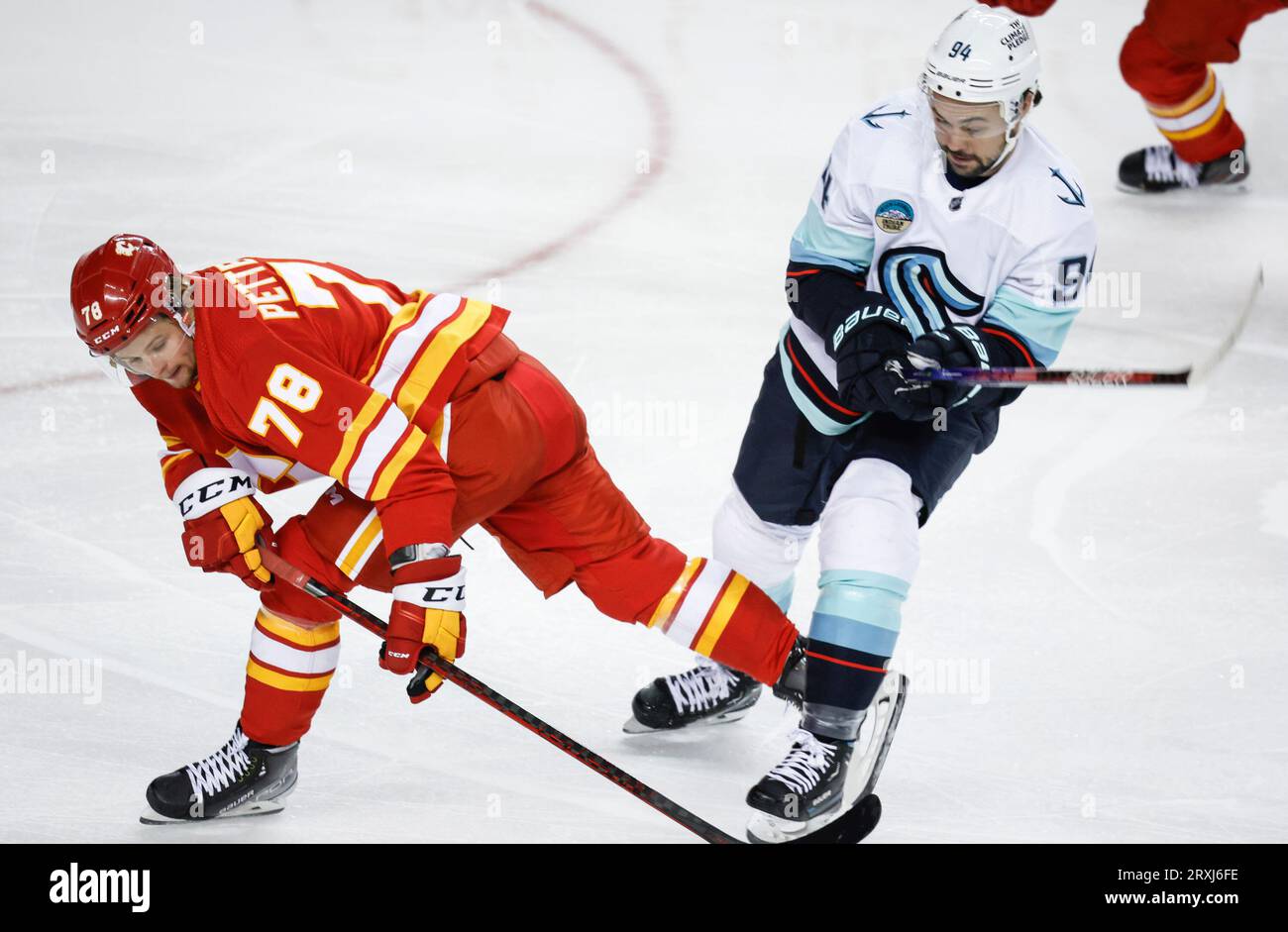 Seattle Kraken forward Devin Shore, right, and Calgary Flames forward ...