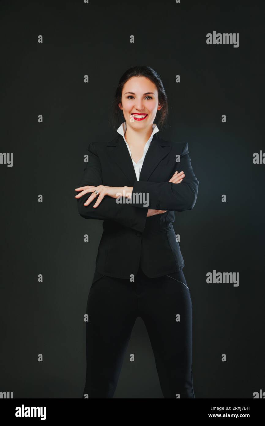 Proudly standing woman in black suit and pants, wearing high heels for ...