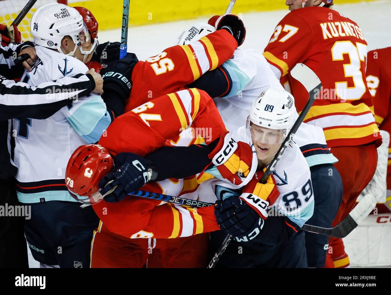 Seattle Kraken forward Ville Petman, right, and Calgary Flames forward ...