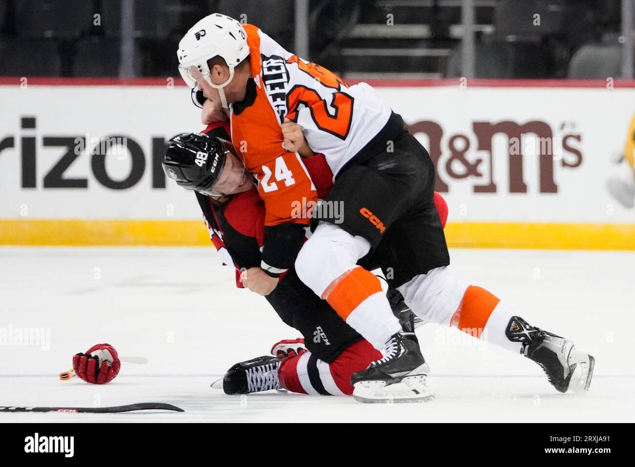 Philadelphia Flyers' Nick Seeler (24) fightrs with New Jersey Devils ...