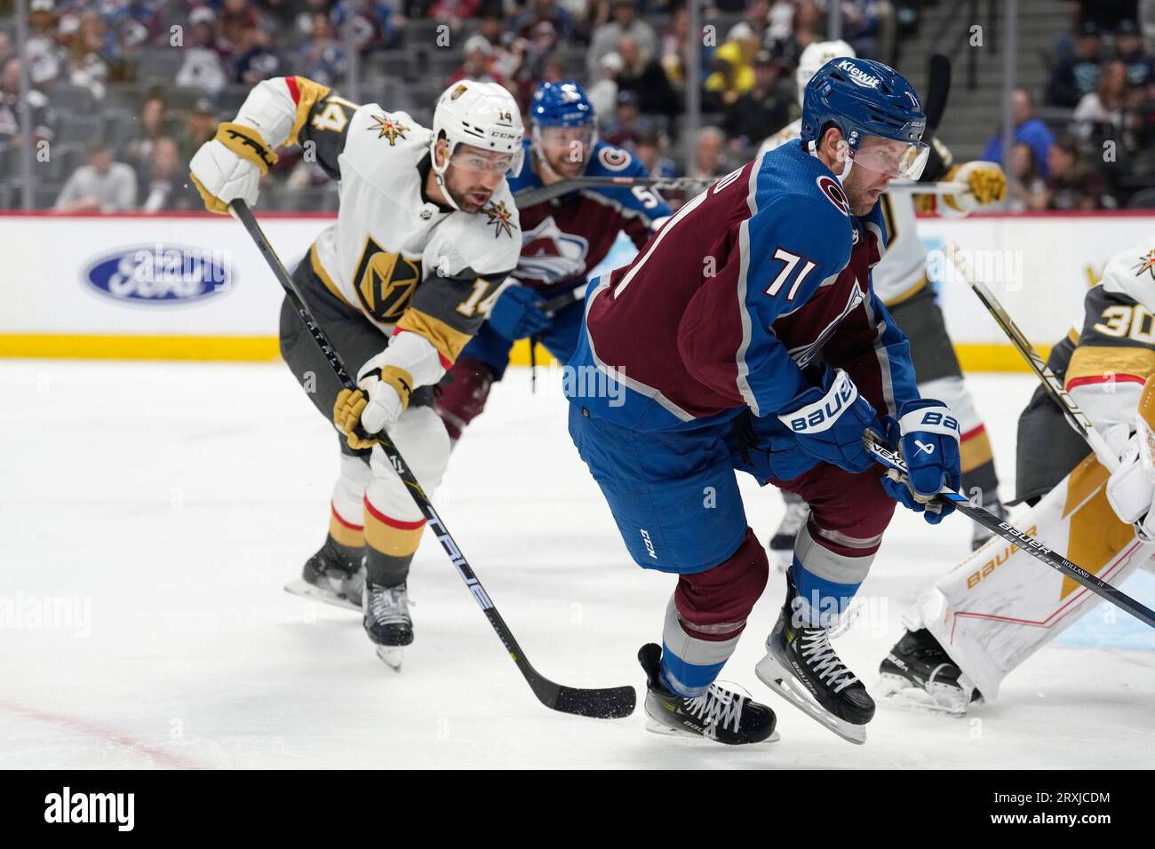 Colorado Avalanche center Peter Holland, right, pursues the puck with ...