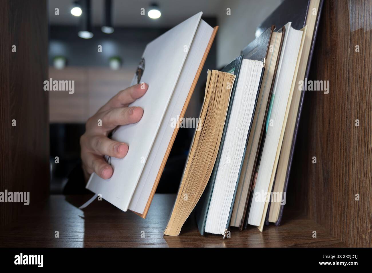 Student picking book from shelf hi-res stock photography and images - Alamy