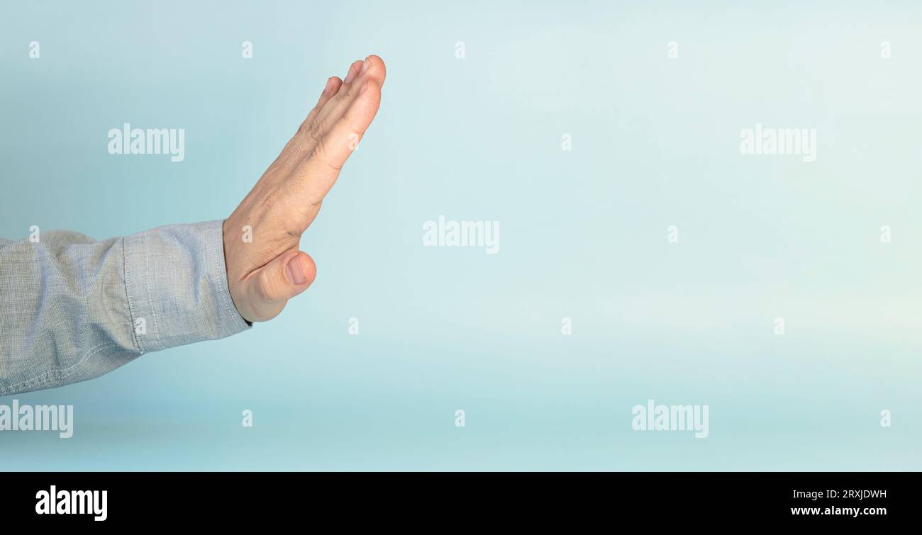 Hand showing sign on blue background. a gesture of refusal made by hand ...