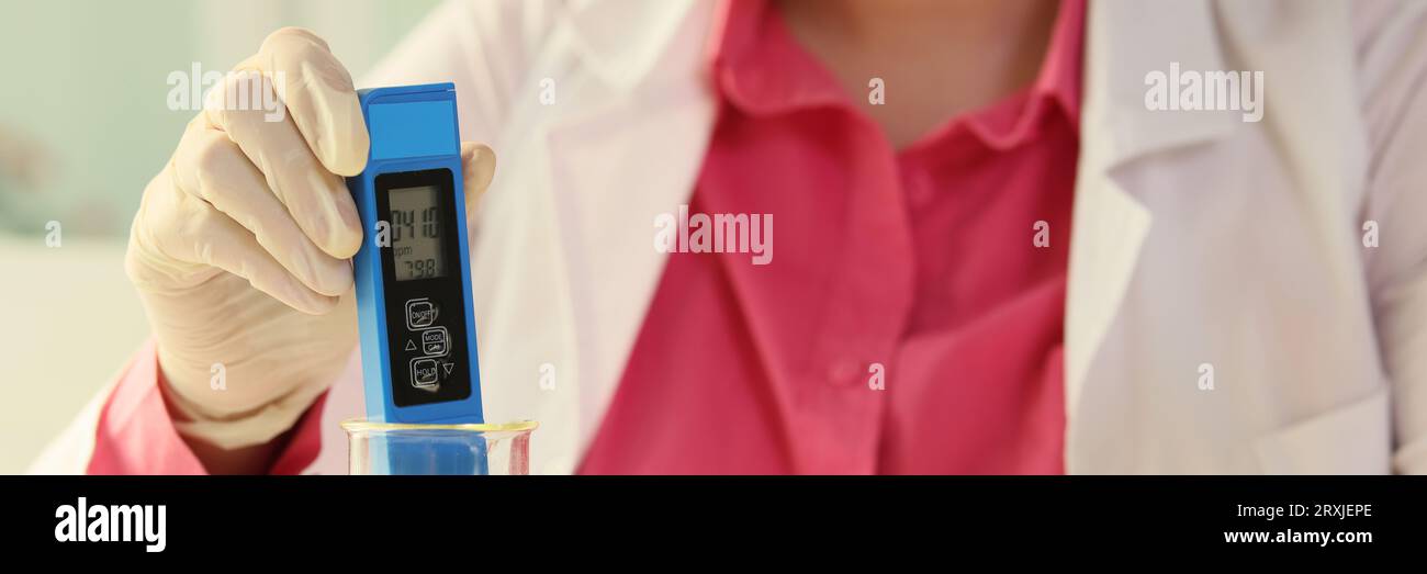 Close-up of scientist measuring properties of liquid sample Stock Photo ...