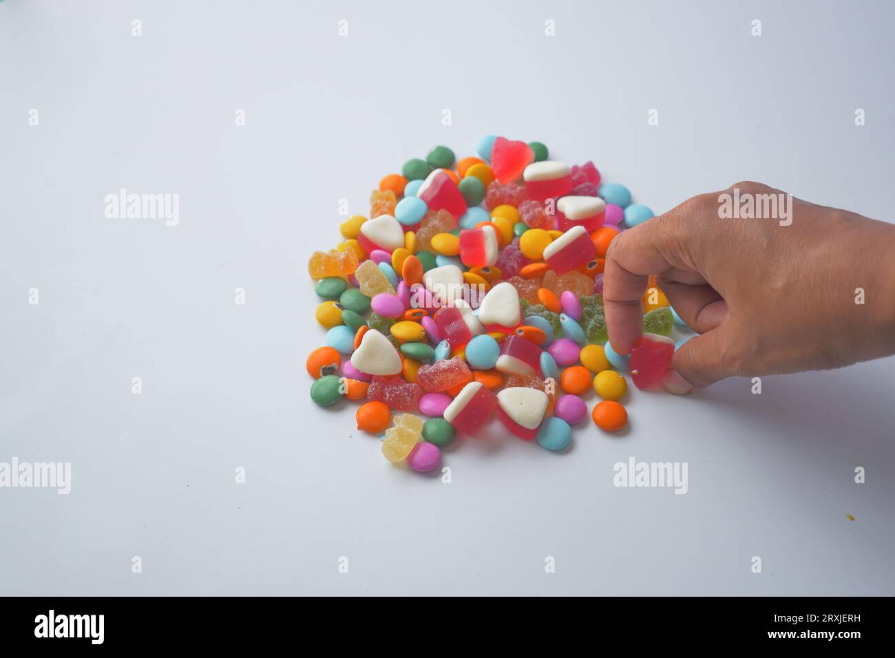 hand pick colorful sweet candy Stock Photo - Alamy