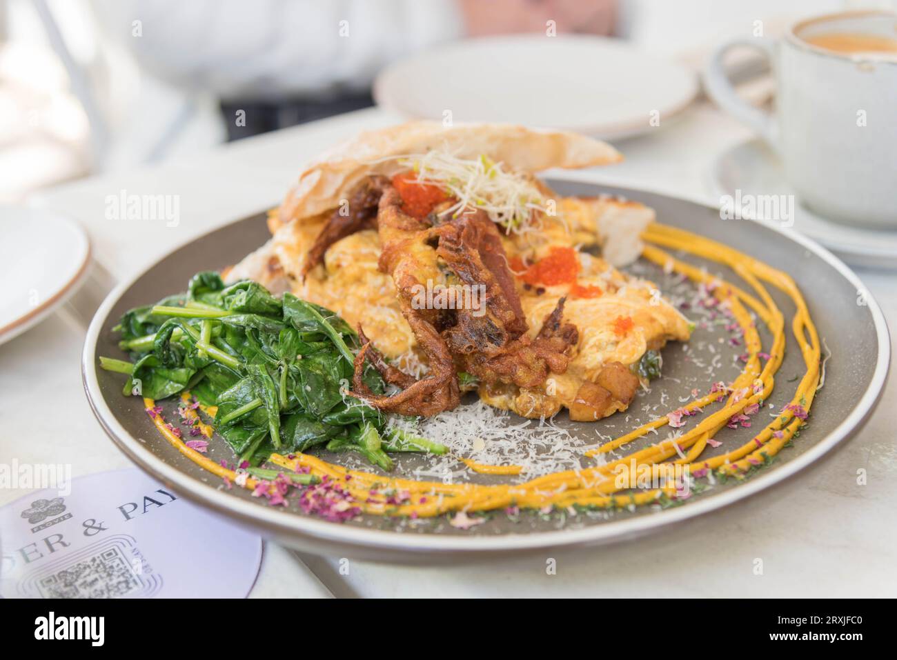 Soft shell crab scrambled egg with a side of sauteed spinach, ciabatta ...