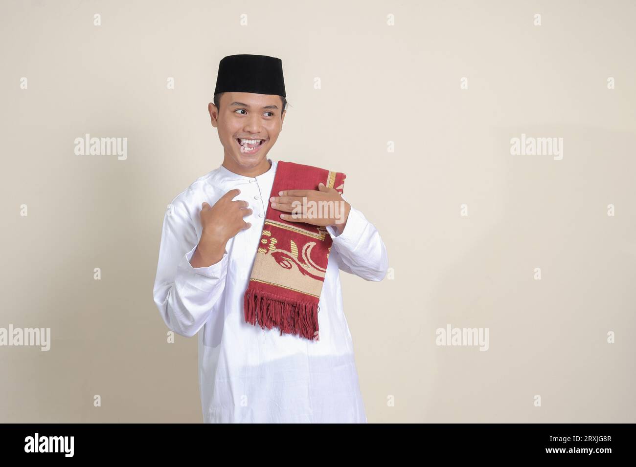 Portrait of attractive Asian muslim man in white shirt pulling hands ...