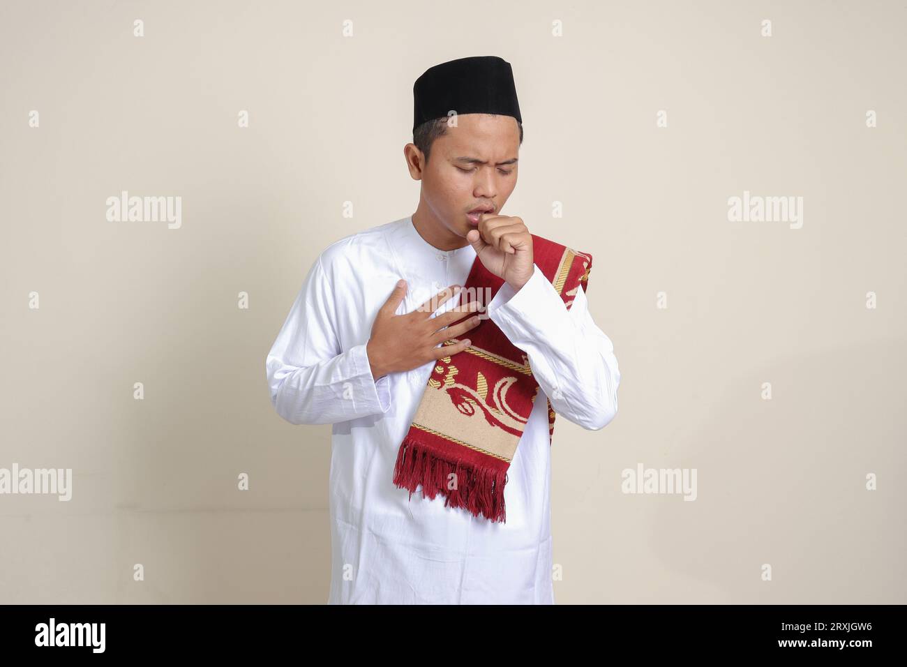 Portrait of attractive Asian muslim man in white shirt keeping hand ...