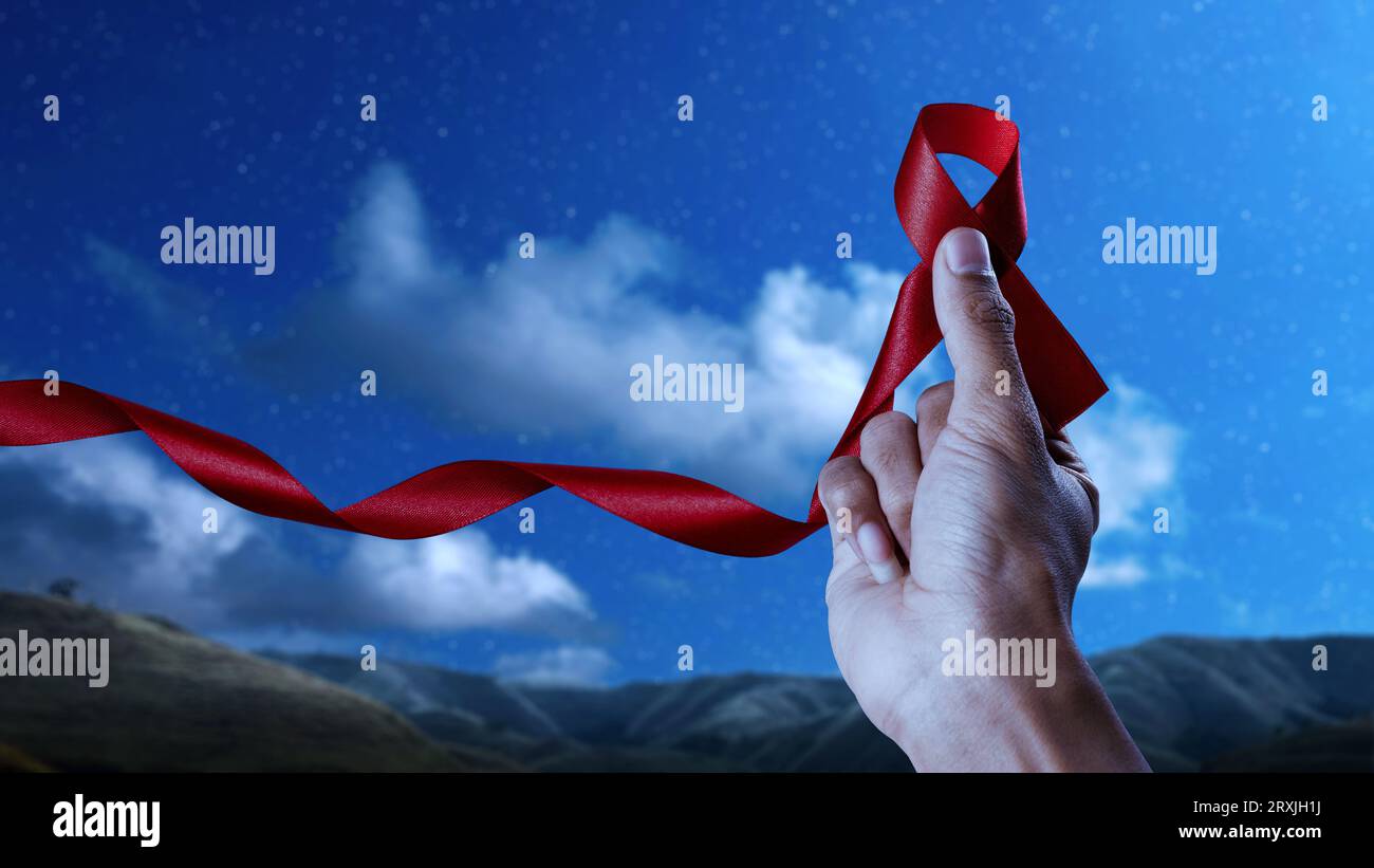 Human hand showing red ribbon awareness. World Aids Day concept Stock ...