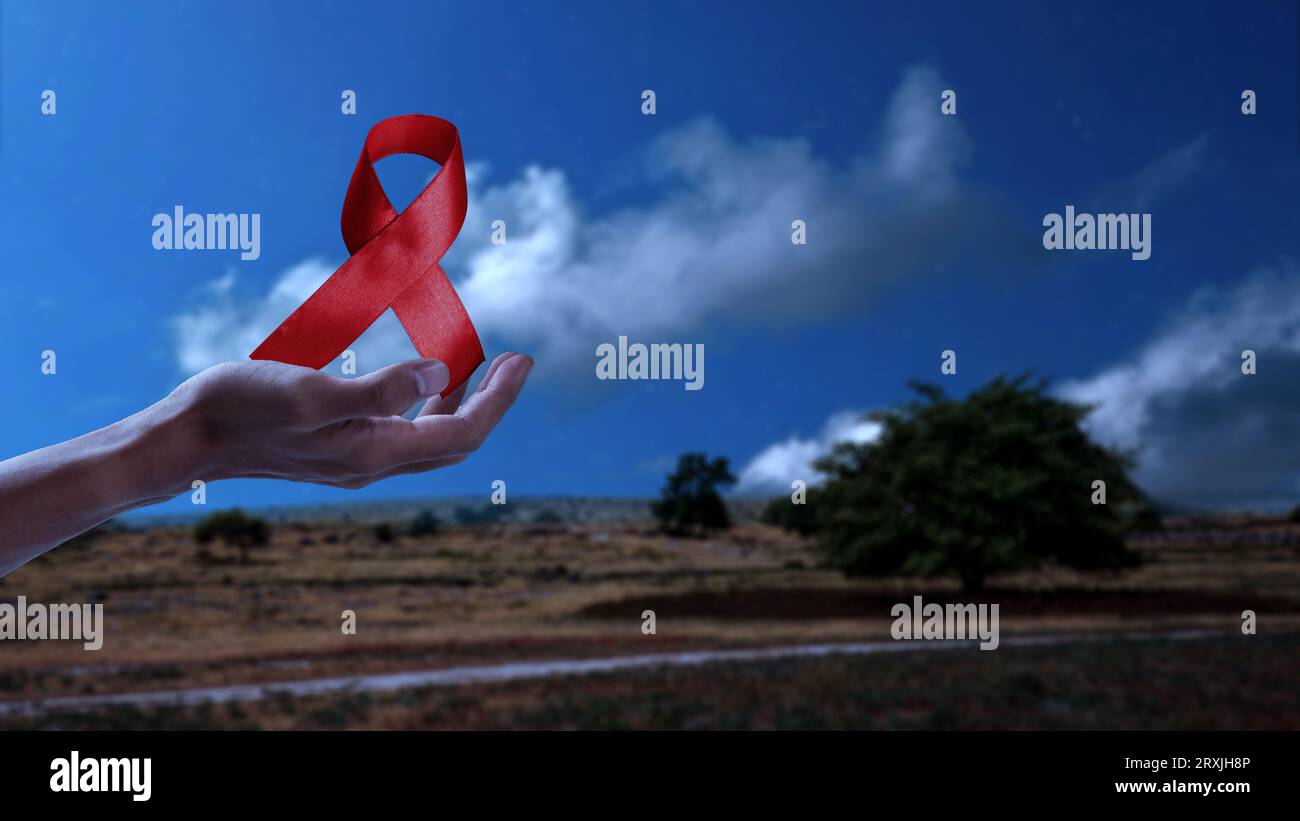 Human hand showing red ribbon awareness. World Aids Day concept Stock ...