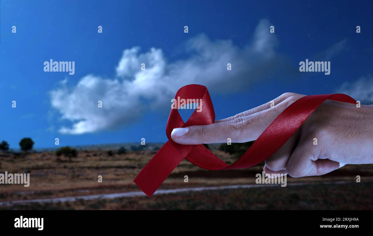 Human hand showing red ribbon awareness. World Aids Day concept Stock ...