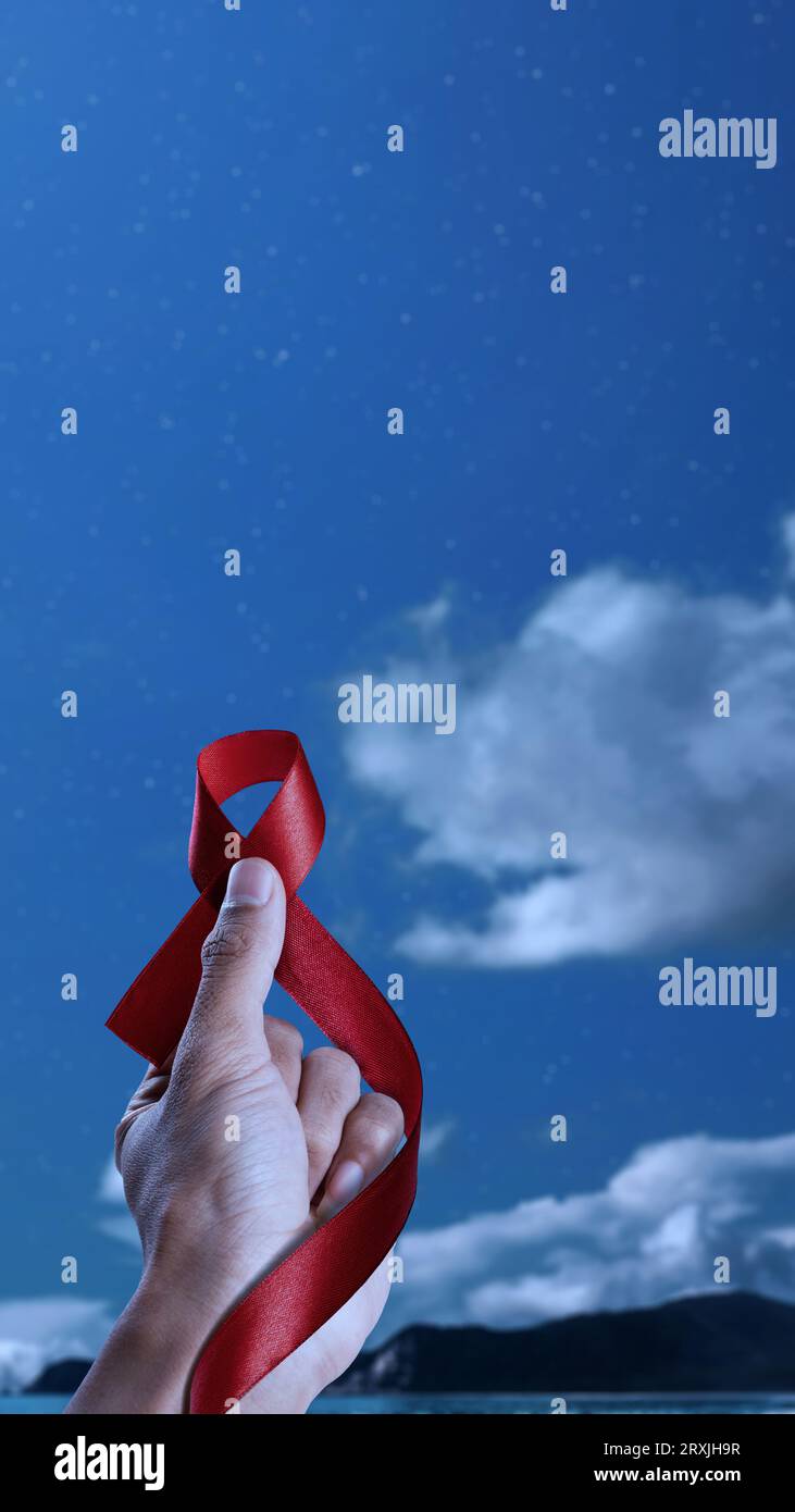 Human hand showing red ribbon awareness. World Aids Day concept Stock ...