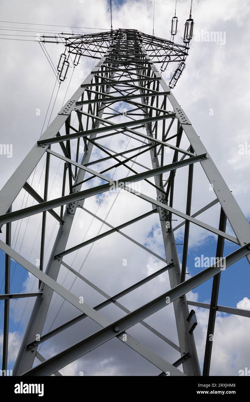 View from below of the tall poles of the high-voltage overhead line ...