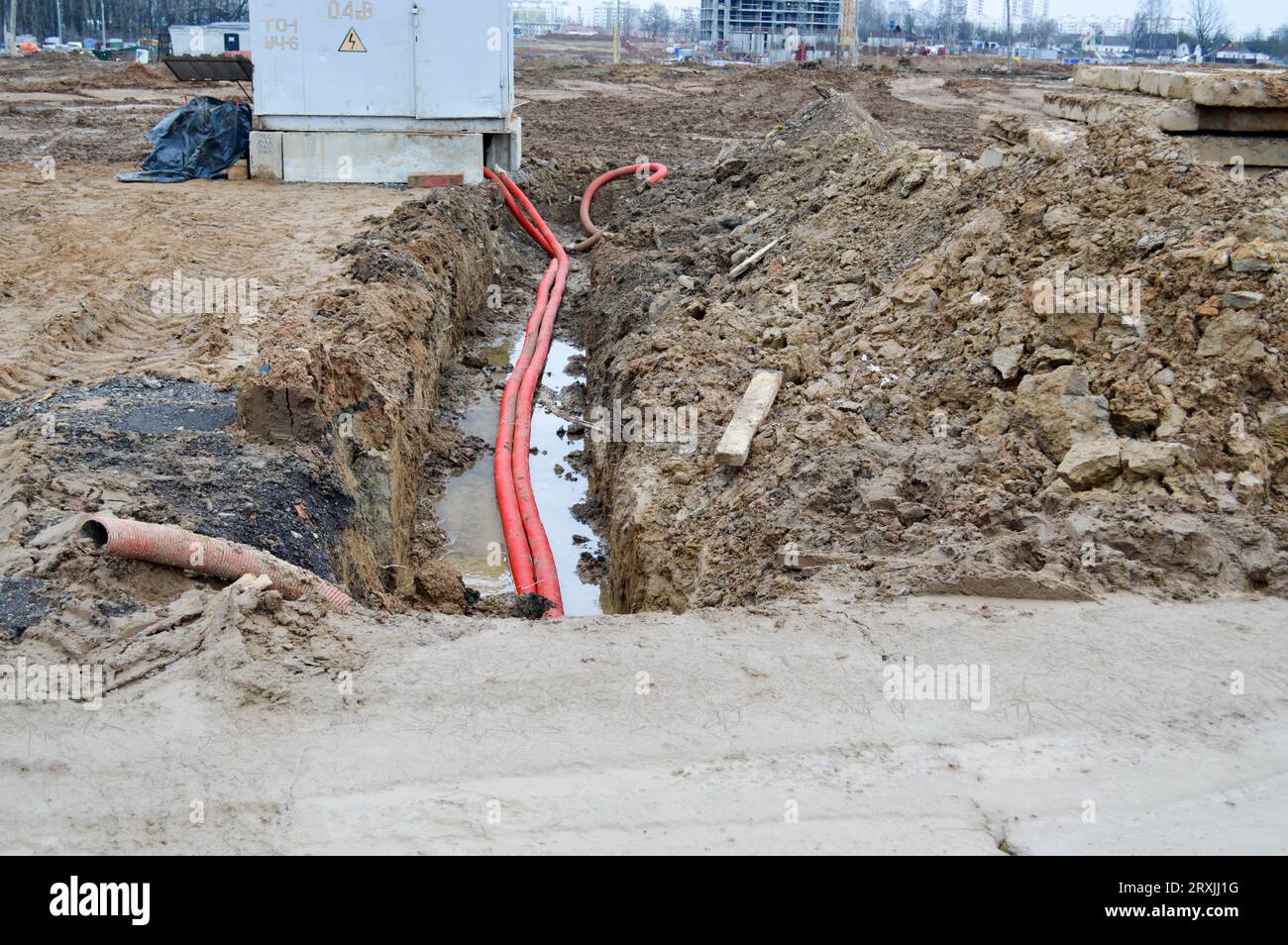 Large red plastic corrugated pipes with wires for a transformer ...