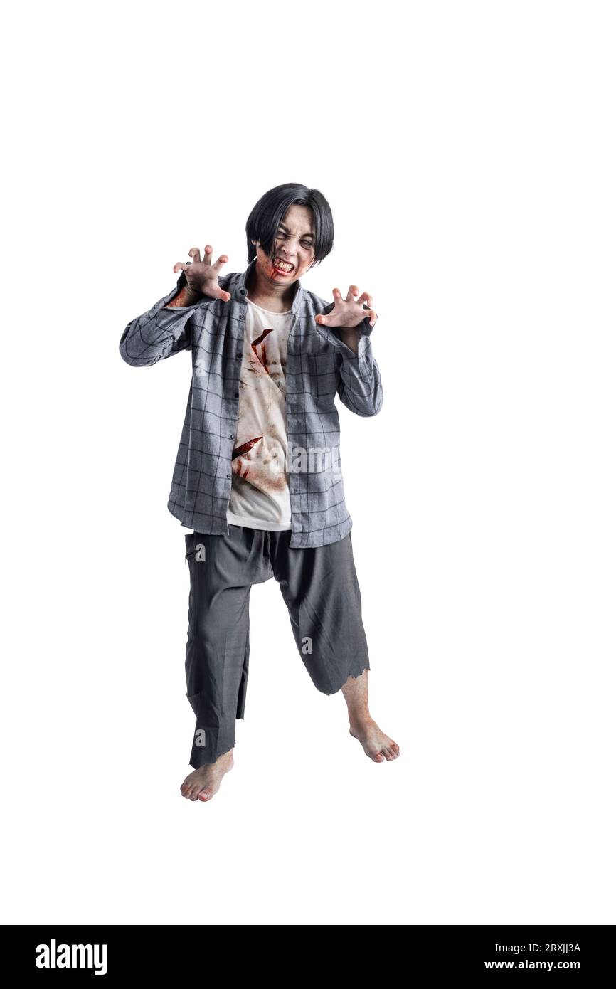 A scary zombie with blood and wounds on his body walking isolated over ...