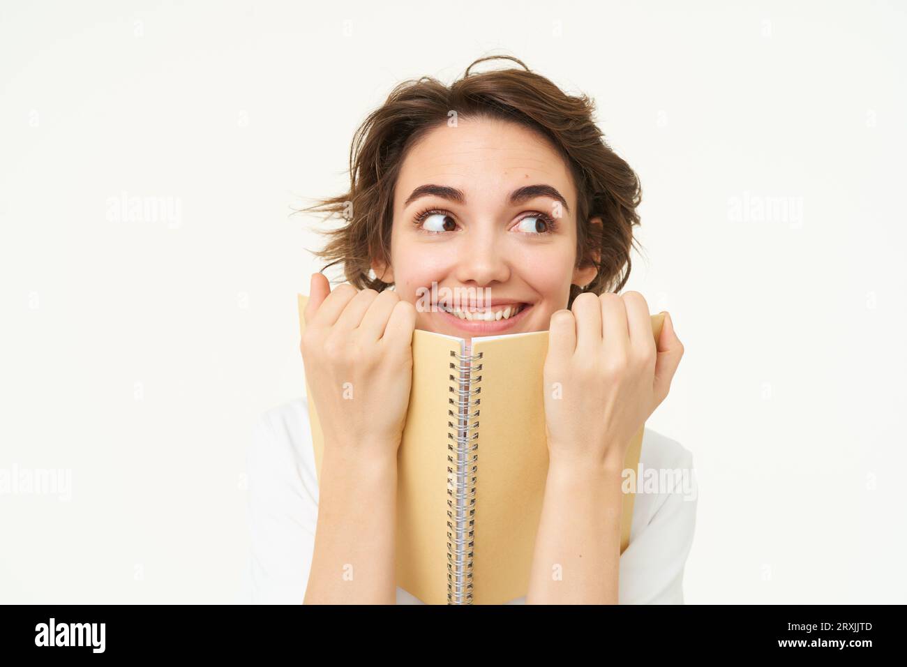 Portrait of happy woman with planner, holding notebook, reading notes ...