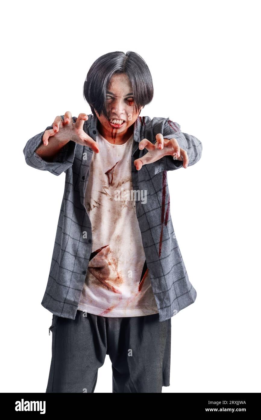 A scary zombie with blood and wounds on his body walking isolated over ...