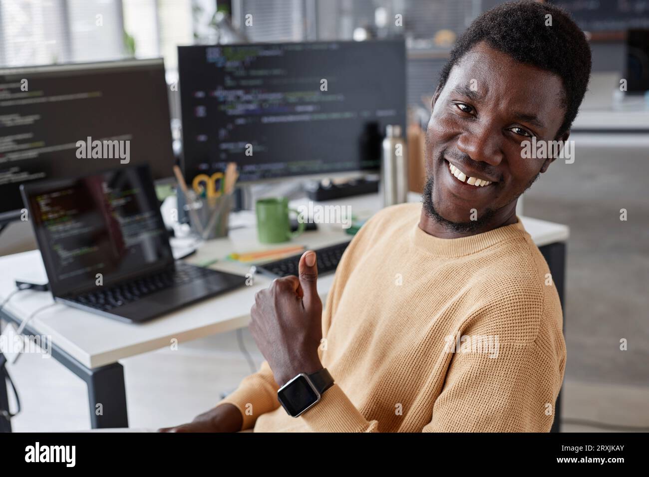 Portrait of African American successful programmer smiling at camera ...